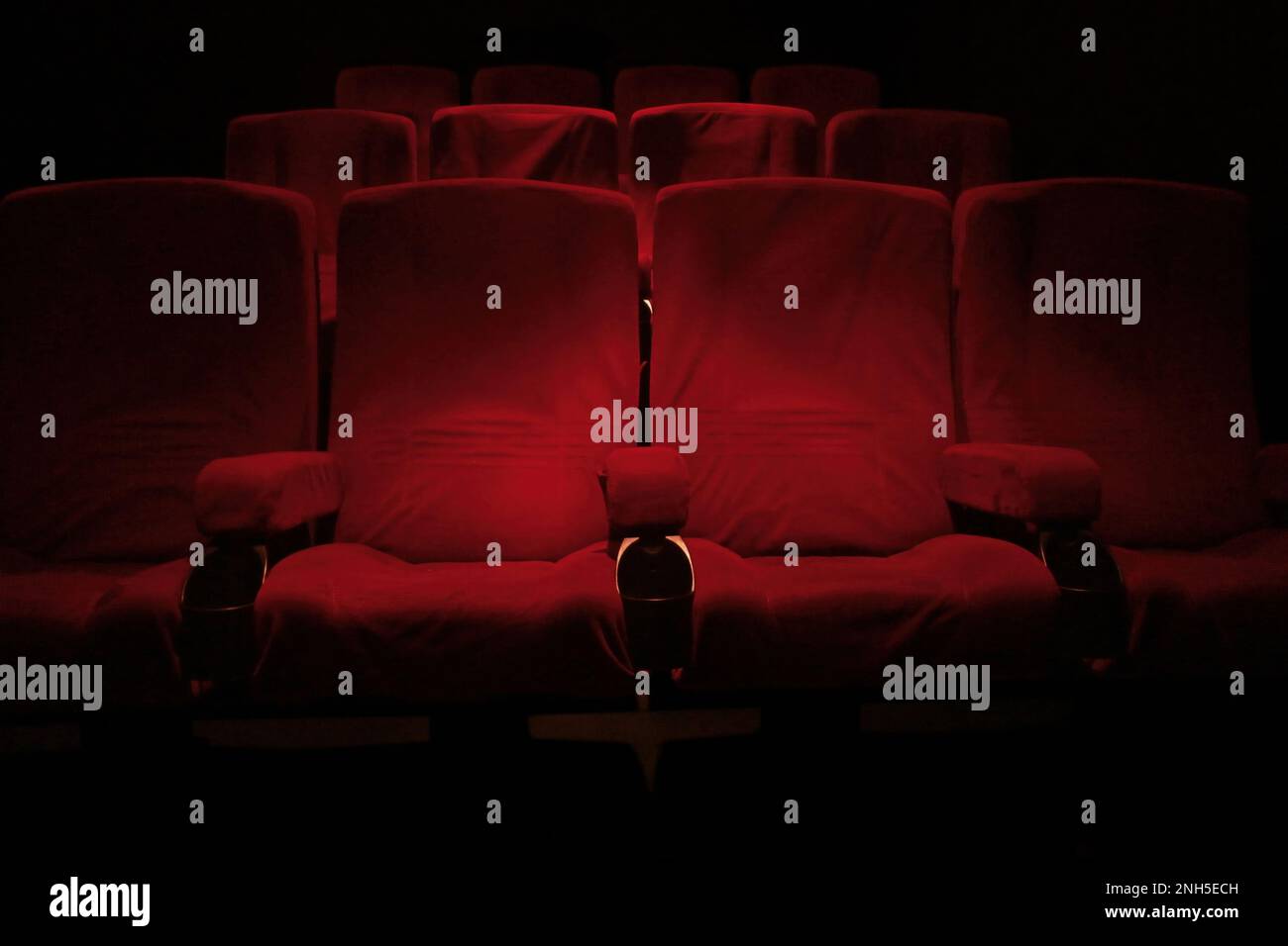 Rows of red velvet seats in a dark and totally empty Stock Photo - Alamy