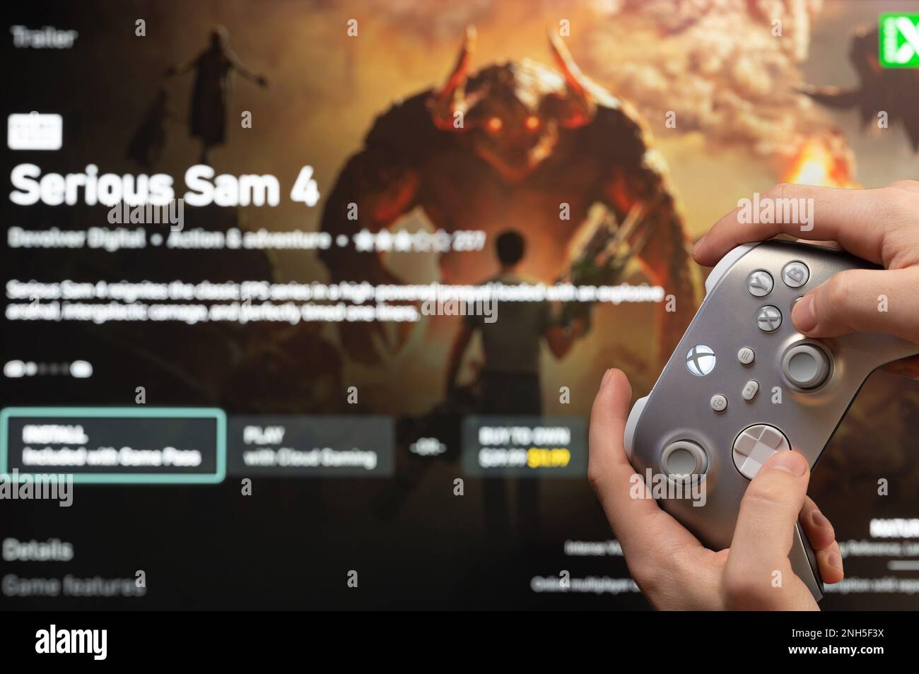 New york, USA - February 20, 2023: Man play WRC game on computer console with xbox joystick in ...