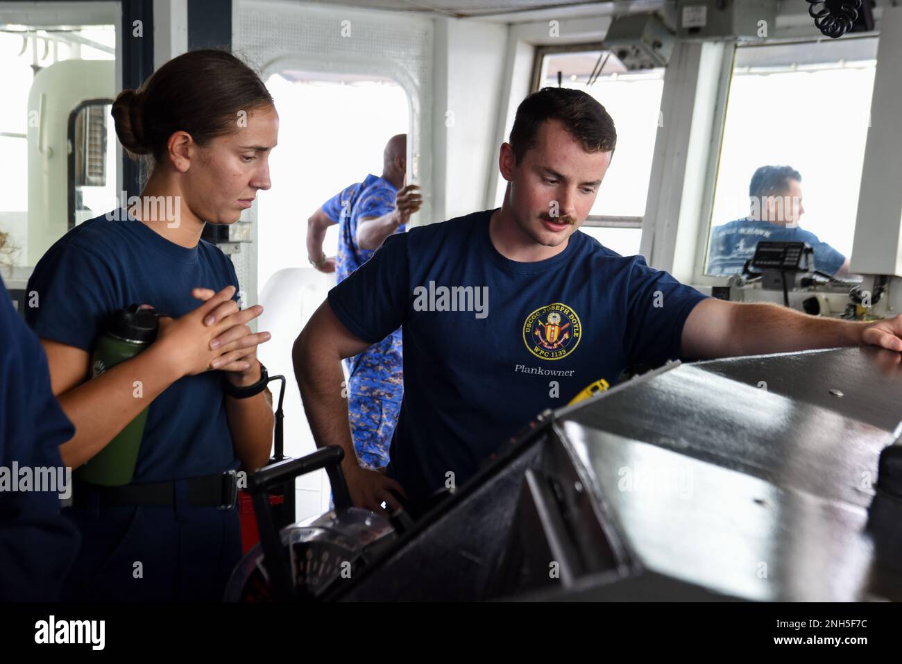 U.S. Coast Guard Ensign Katherine Pittman, left, and Lt. Scott Ledoux ...