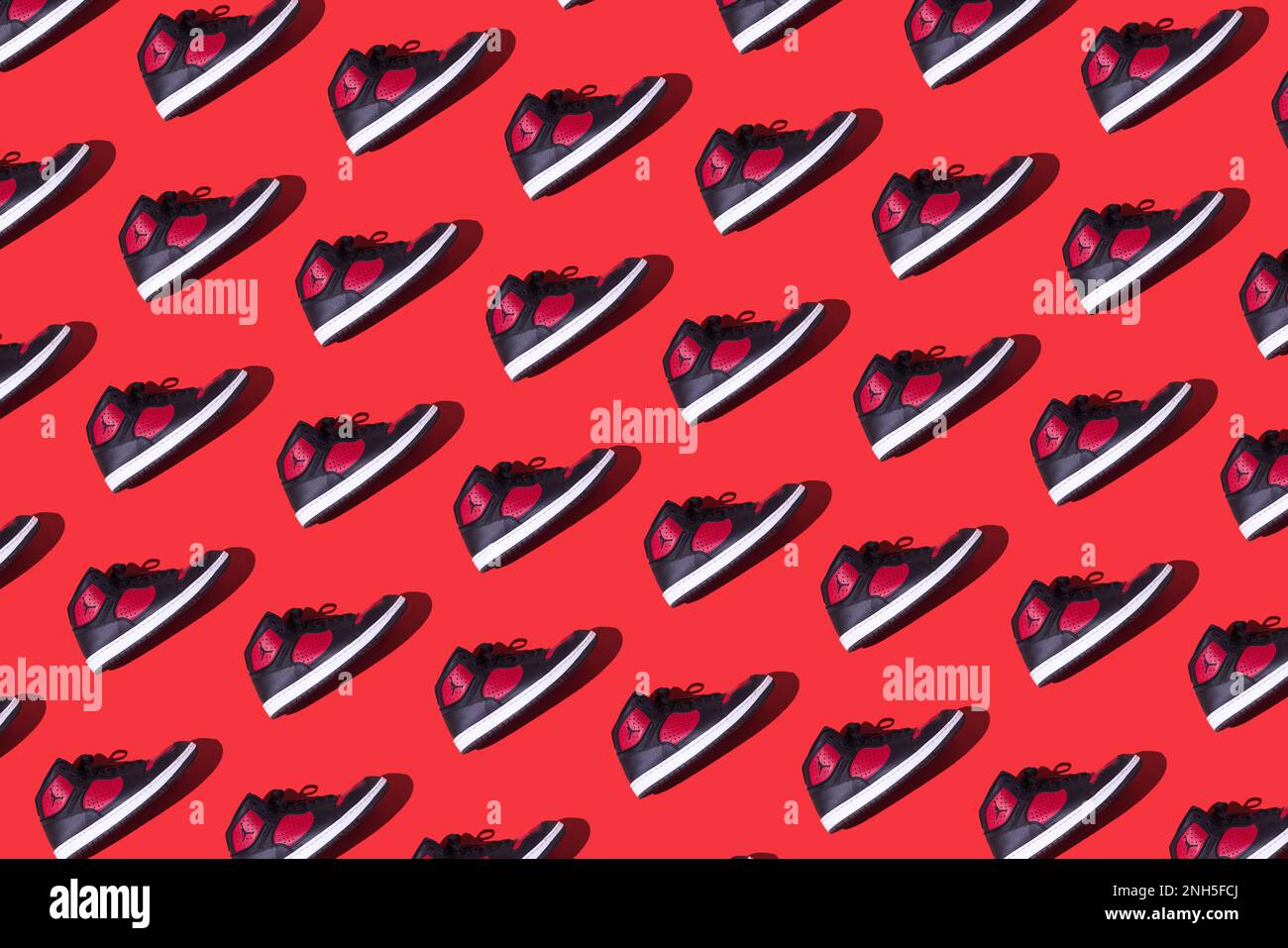 Pattern of NIKE Jordan Access sneakers in black and red, on a red ...