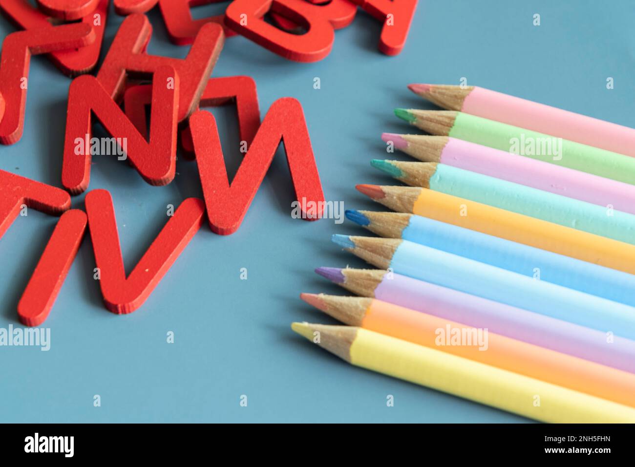 Back to school concept with assorted letters and colored pencils in ...