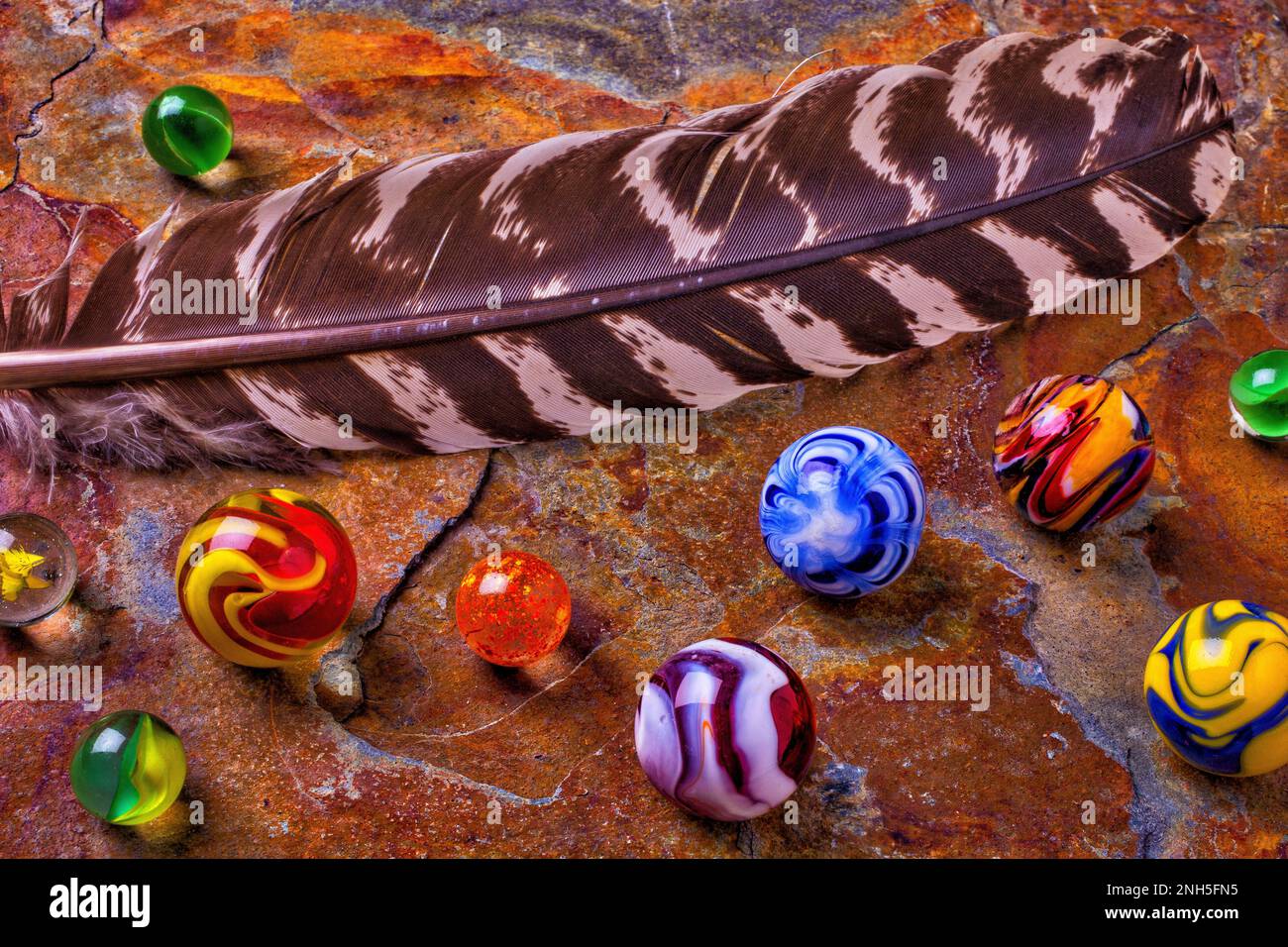 Feather And Marbles Stock Photo - Alamy