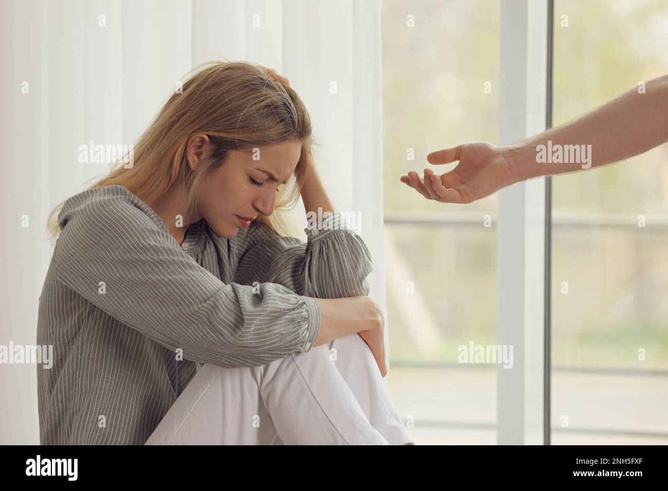 Woman offering help man sitting hi-res stock photography and images - Alamy