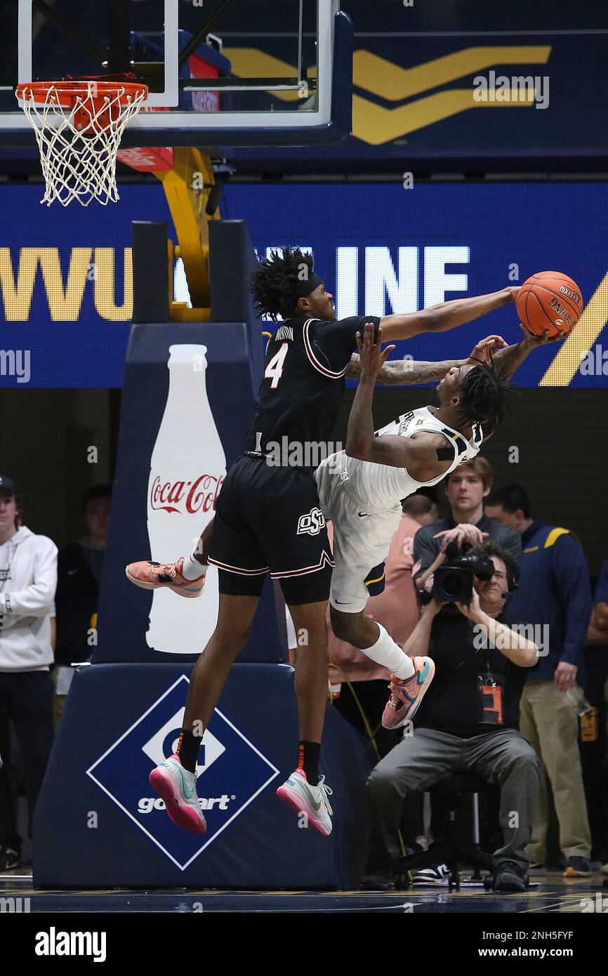 West Virginia guard Kedrian Johnson, right, is defended by Oklahoma ...