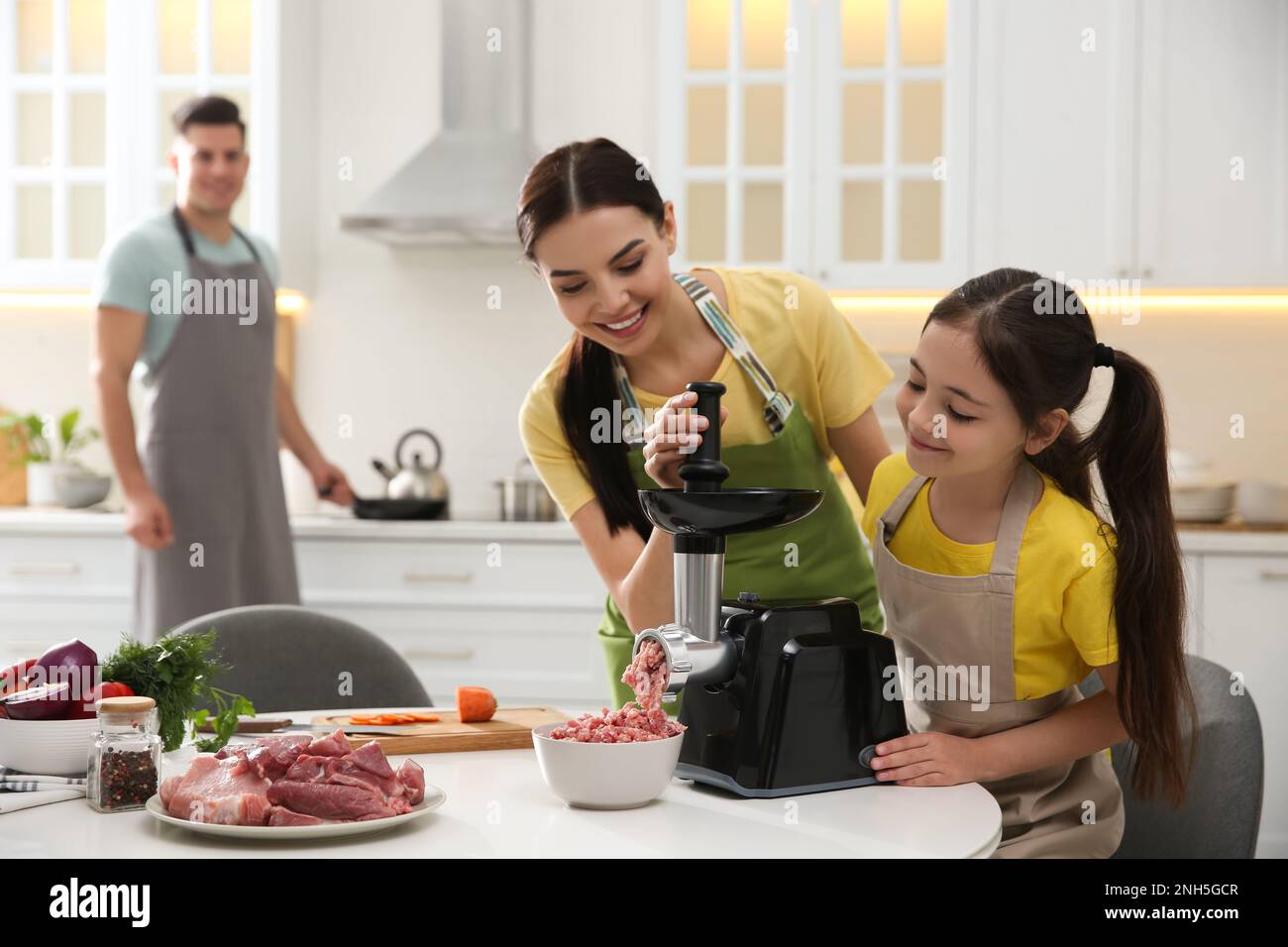 Happy family making dinner together in kitchen, mother and daughter ...