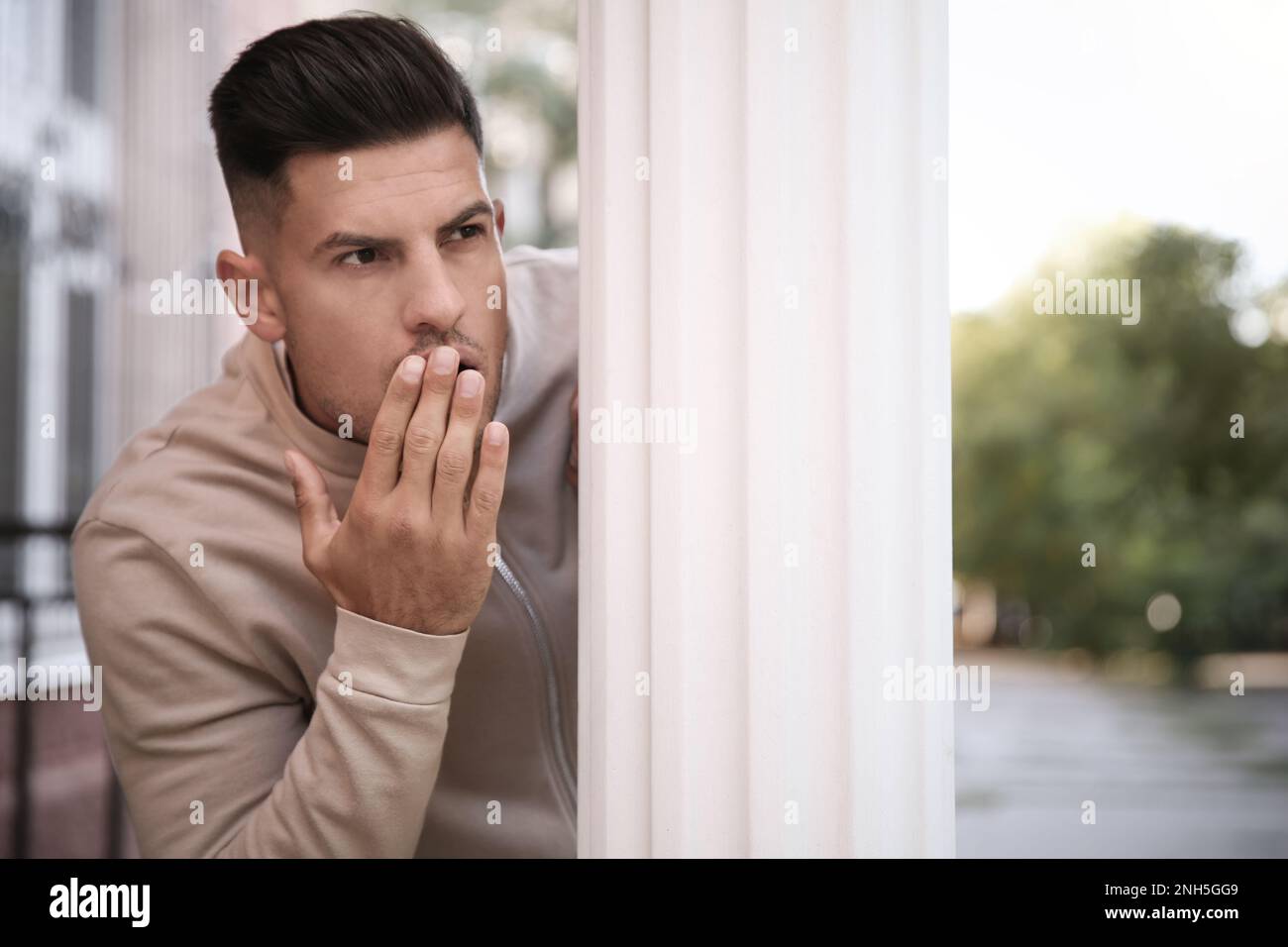 Man spying on his girlfriend in park. Cheating concept Stock Photo - Alamy