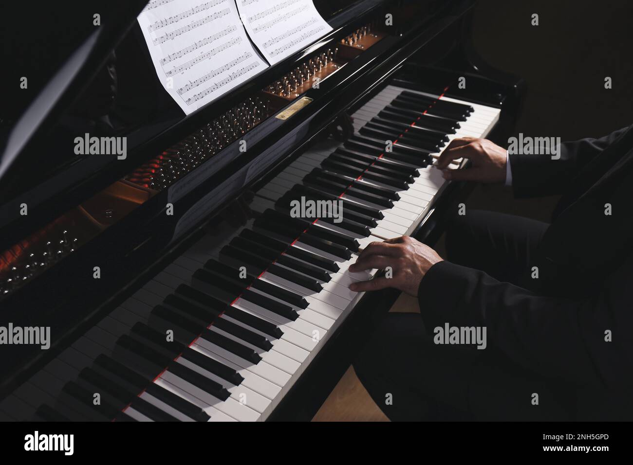Man playing grand piano, closeup. Talented musician Stock Photo - Alamy