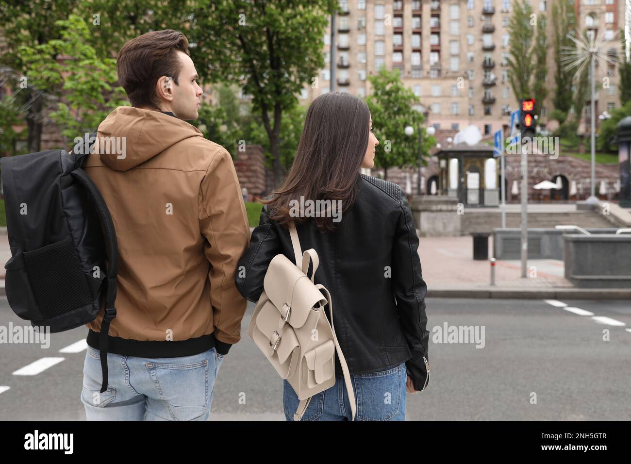 People waiting to cross street, back view. Traffic rules and ...