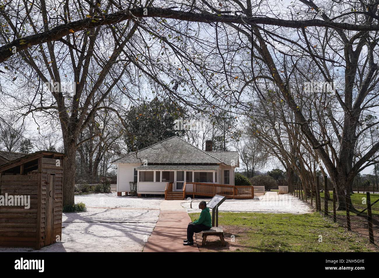 A visitor sits on a bench at the childhood home of former U.S ...