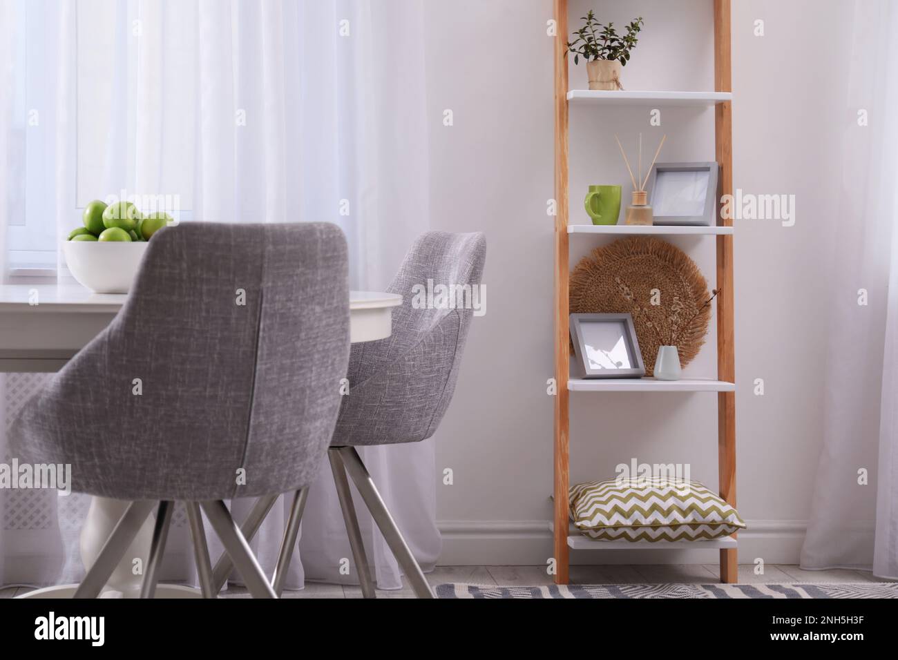 Stylish living room interior with wooden ladder near white wall Stock ...