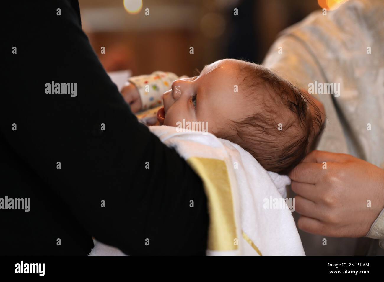 Man holding adorable baby in church during baptism ceremony, closeup ...