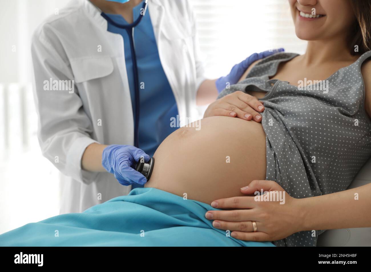 Doctor examining woman before giving child birth in maternity hospital ...