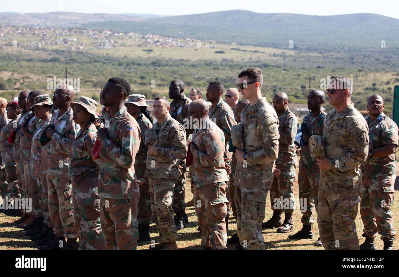 U.S. and South African Soldiers bow their heads for prayer during the ...