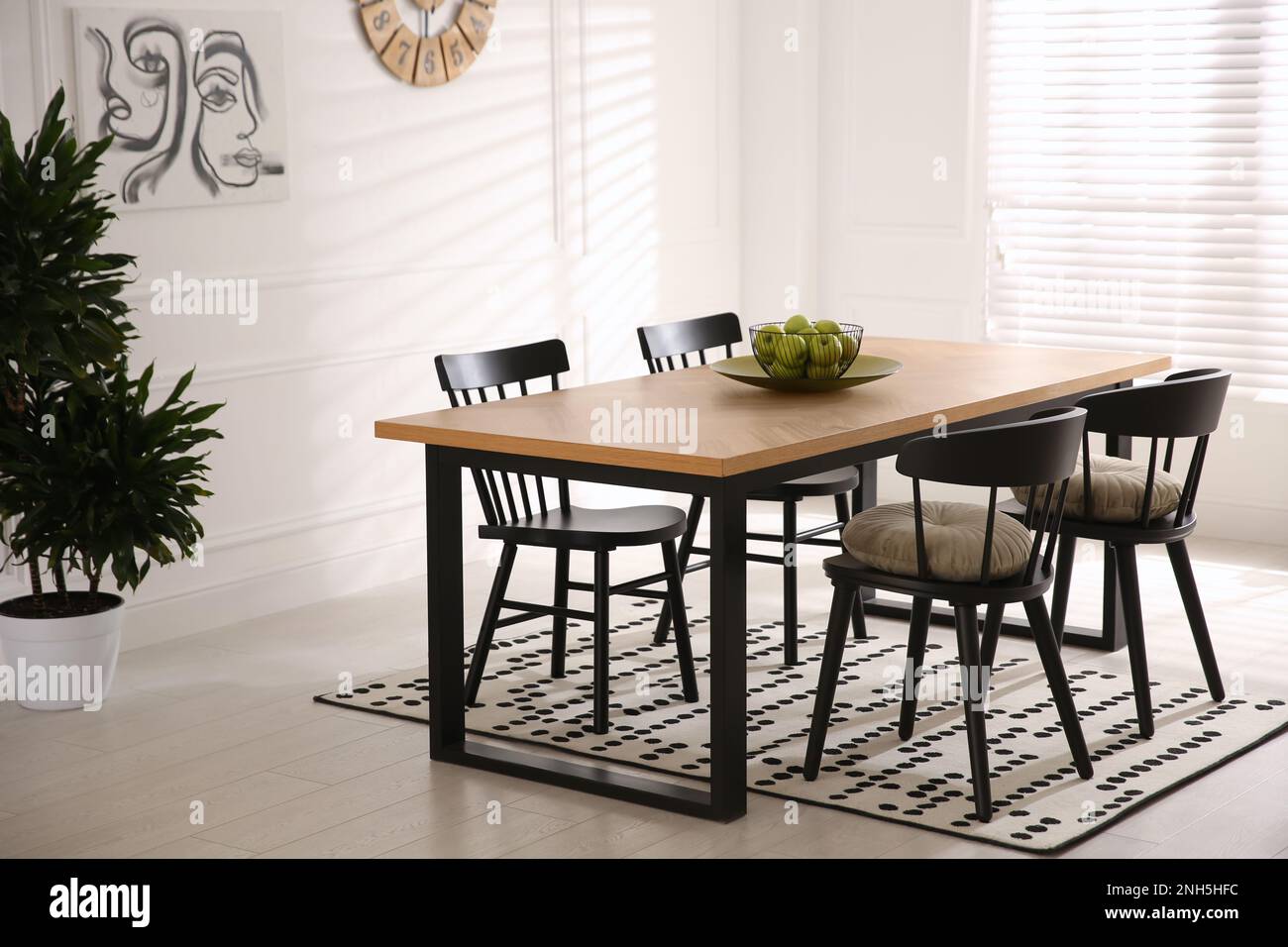 Stylish wooden dining table and chairs in room. Interior design Stock ...
