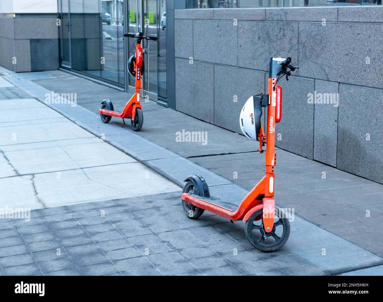 Neuron electric scooters left on side of footpath, Calgary, 2 Street SW ...