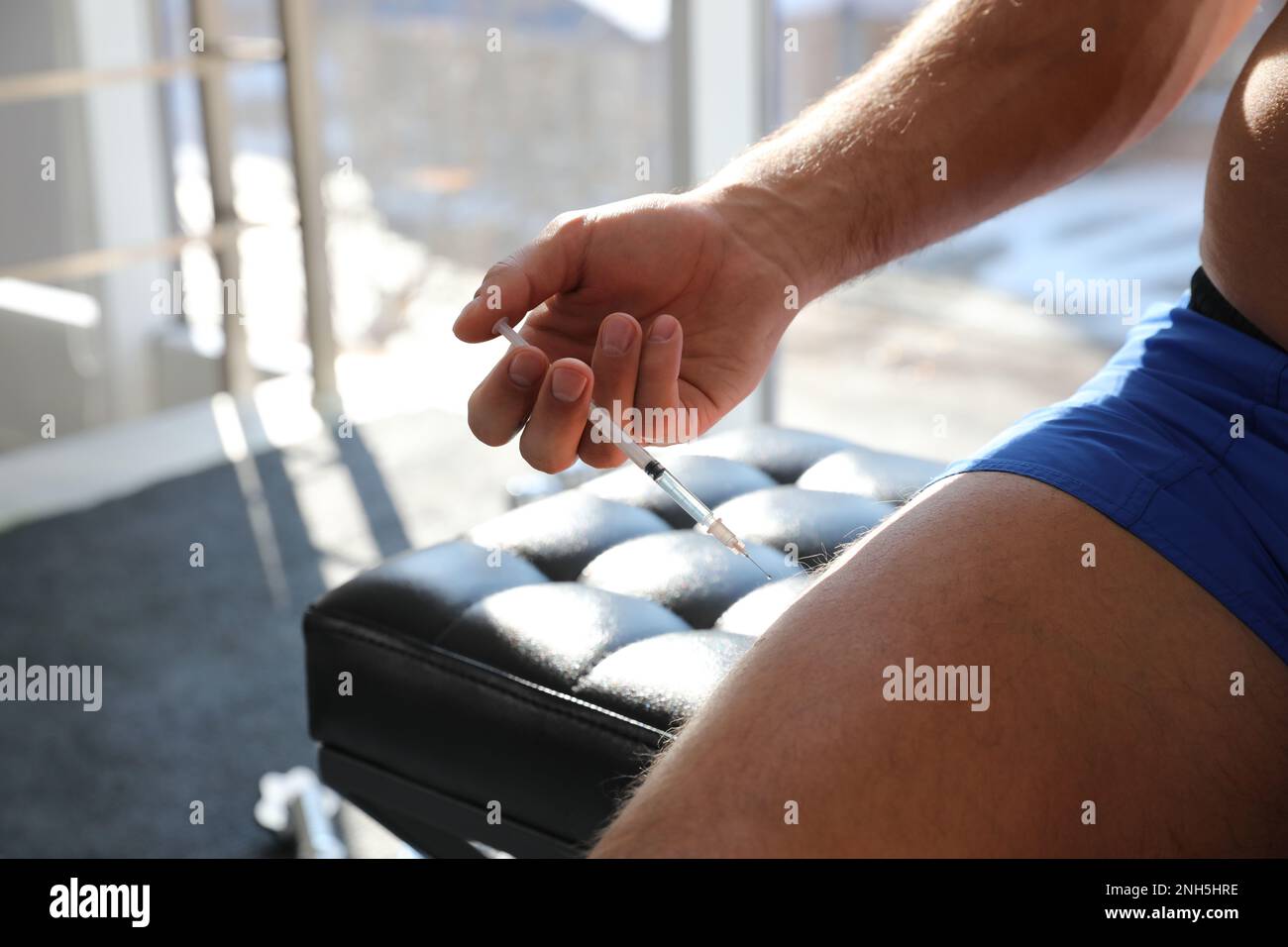Man injecting himself indoors, closeup. Doping concept Stock Photo - Alamy