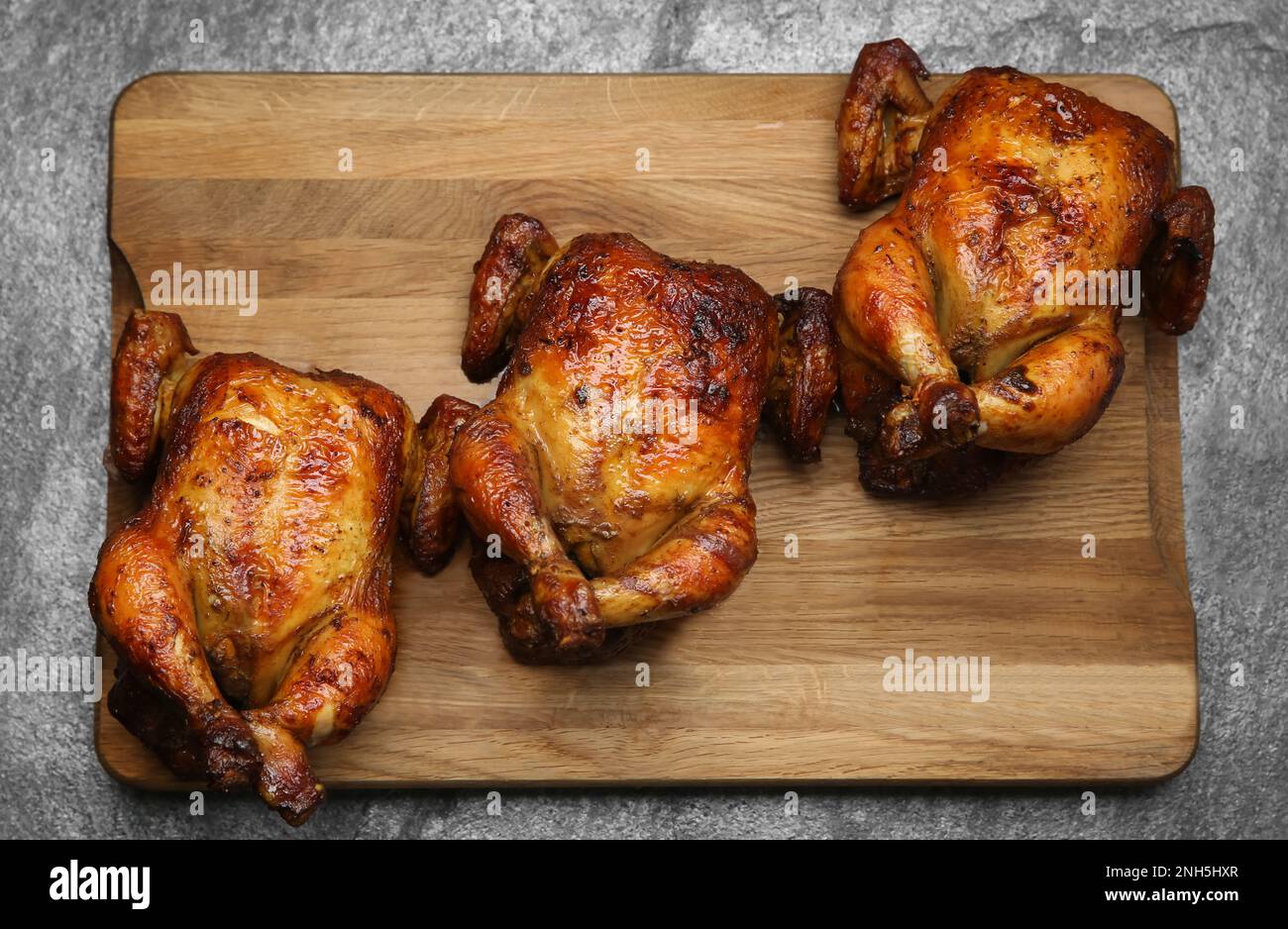 Delicious grilled whole chickens on grey table, top view Stock Photo ...