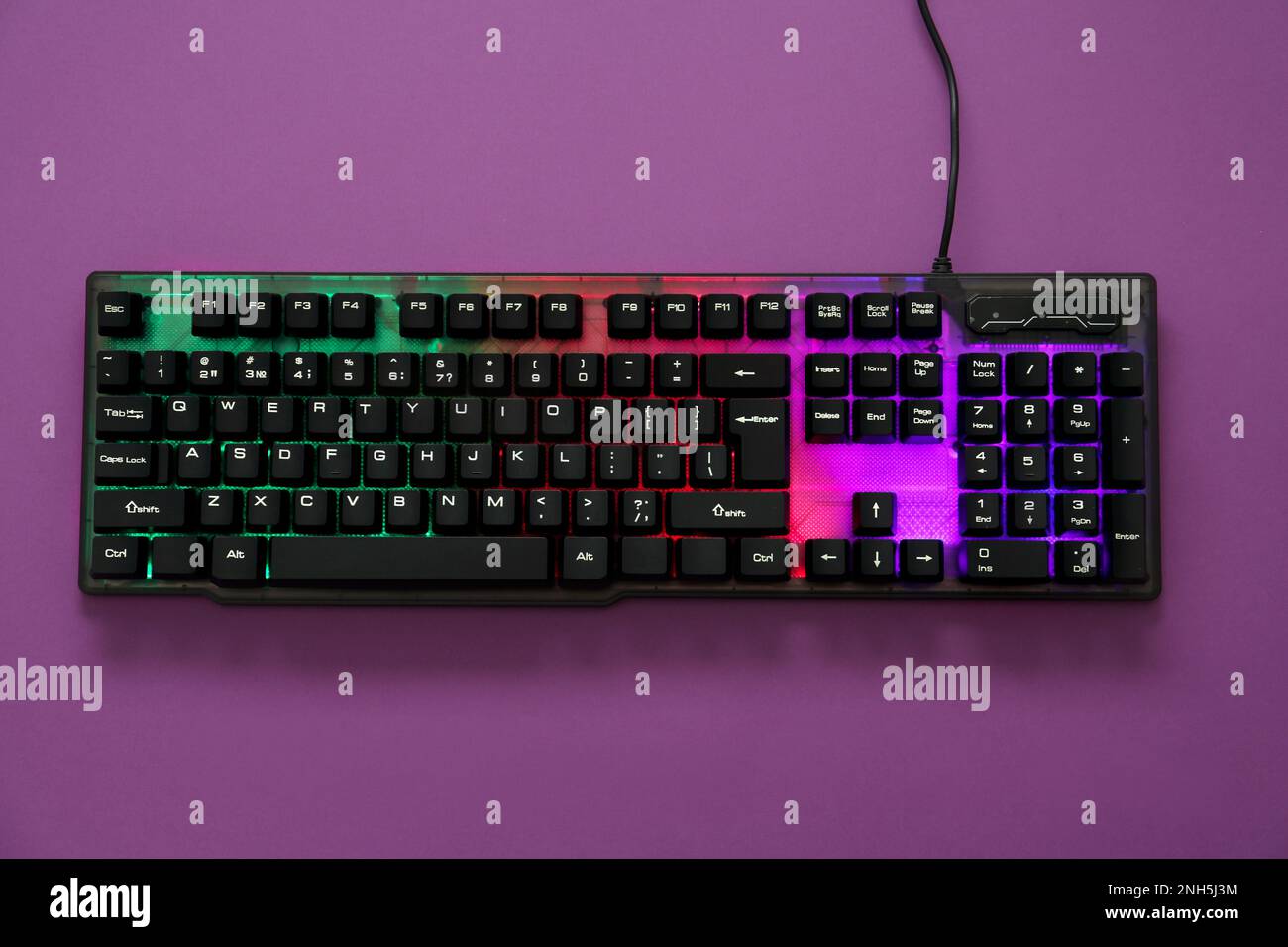 Modern RGB keyboard on purple background, top view Stock Photo - Alamy