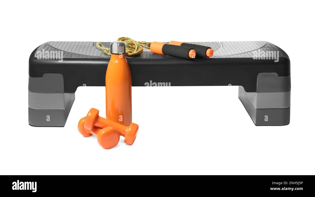 Step platform, jump rope, dumbbells and bottle on white background ...