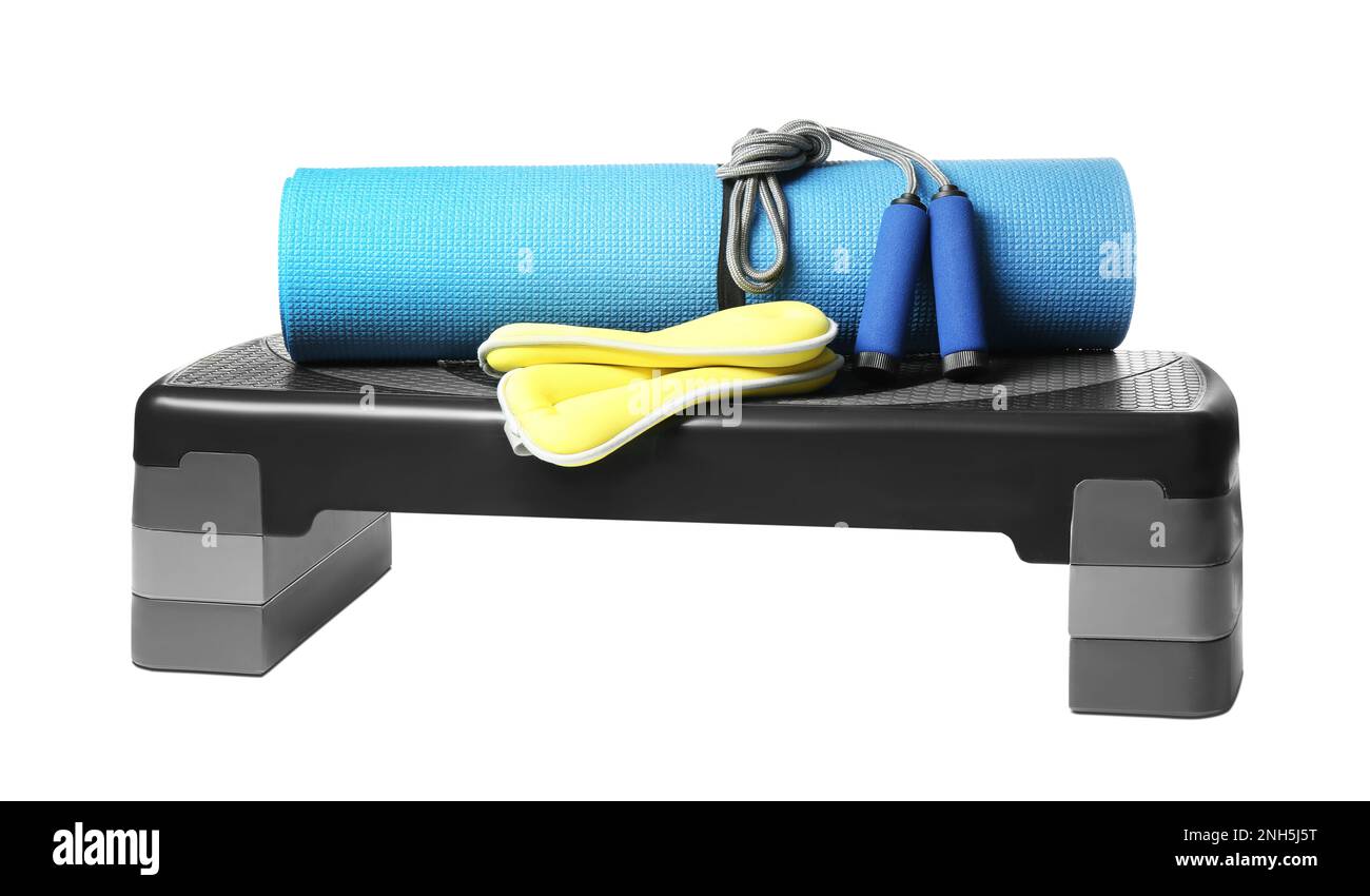 Step platform, mat, weights and jump rope on white background. Sports ...