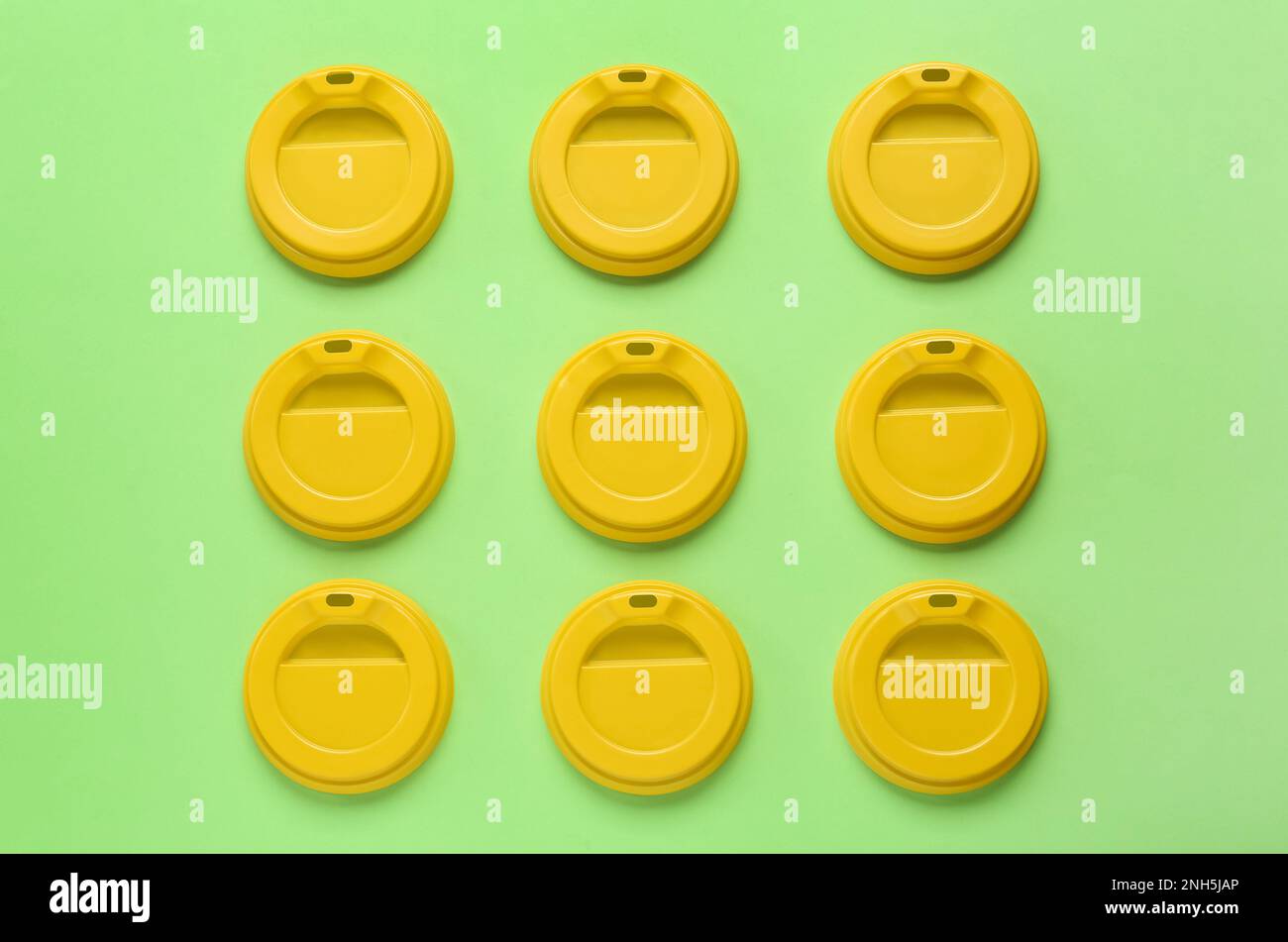 Plastic caps for disposable cups on green background, flat lay Stock ...