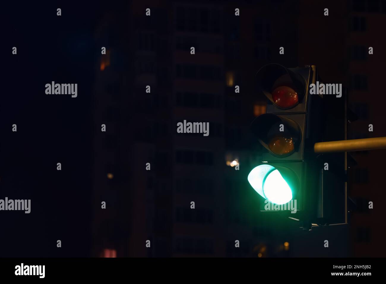View of traffic light in city at night Stock Photo - Alamy