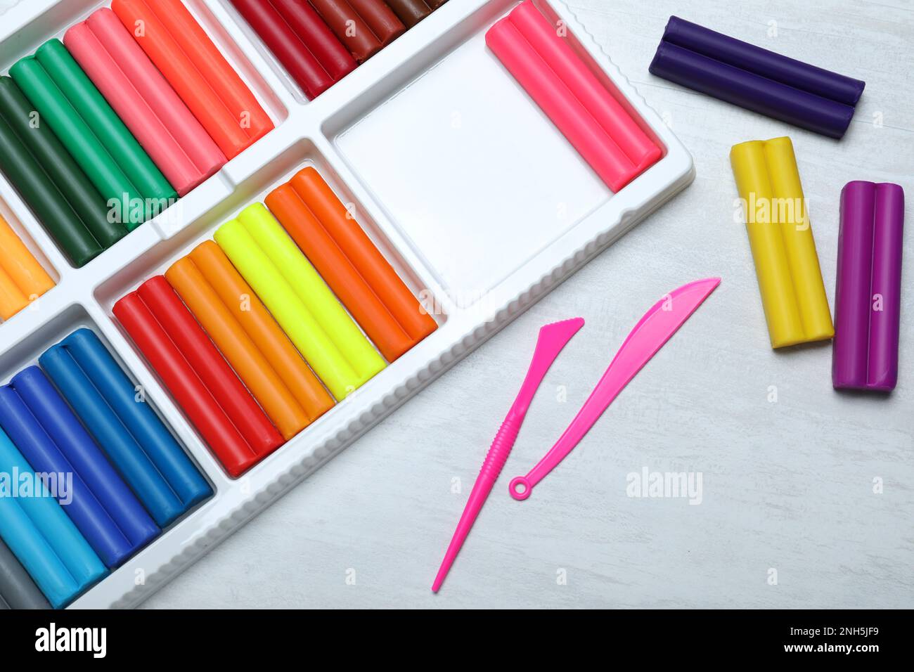 Colorful plasticine and tools on white table, flat lay Stock Photo - Alamy