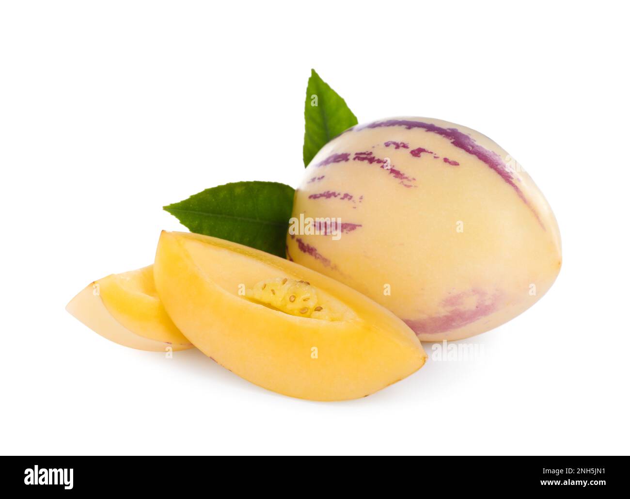 Whole and cut fresh pepino melons with green leaves on white background ...