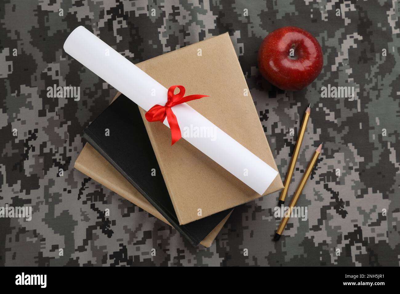 Flat lay composition with books and diploma on camouflage background ...