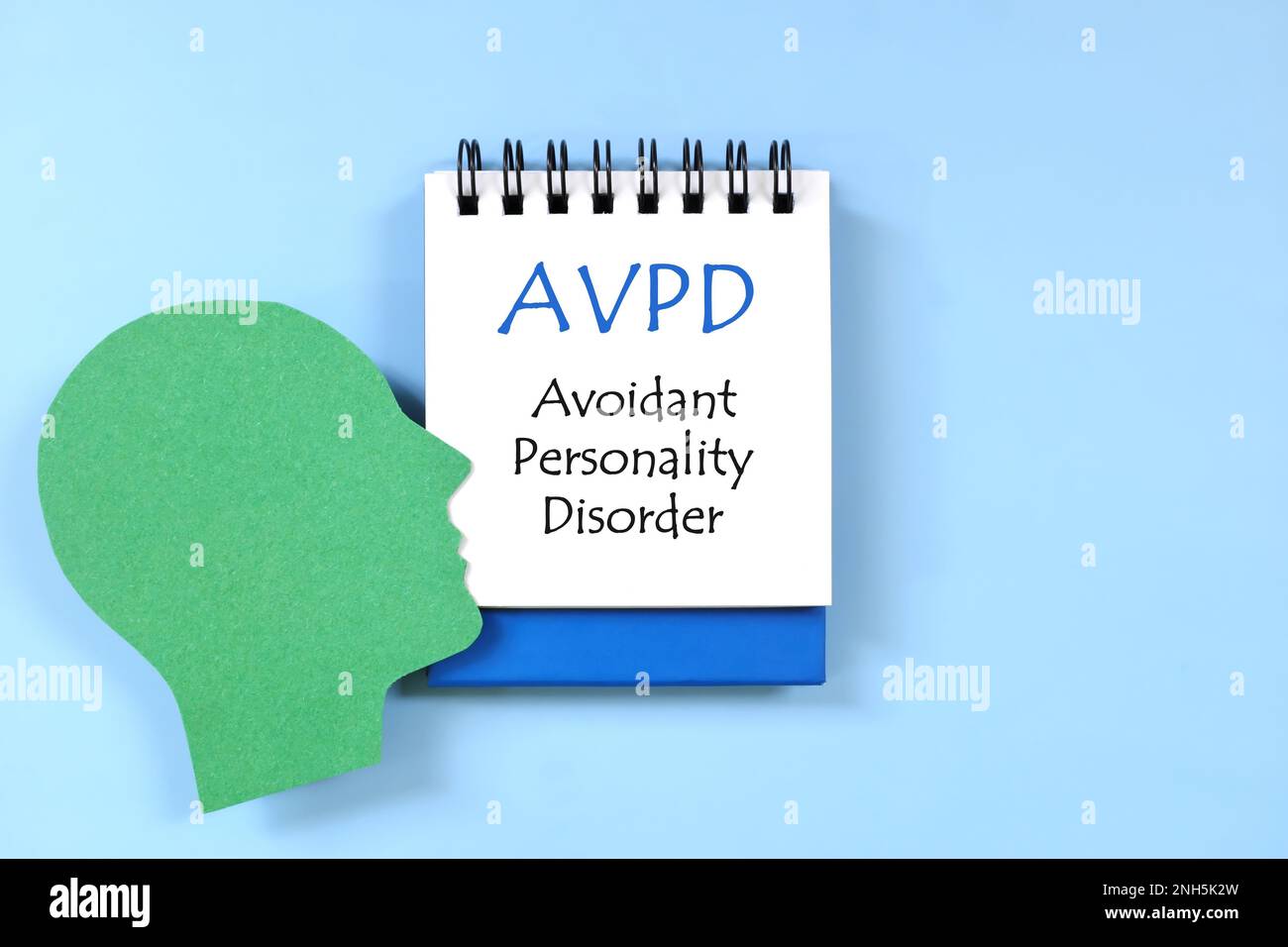 Avoidant personality disorder or AVPD diagnosis written on notepad in blue background. Flat lay ...