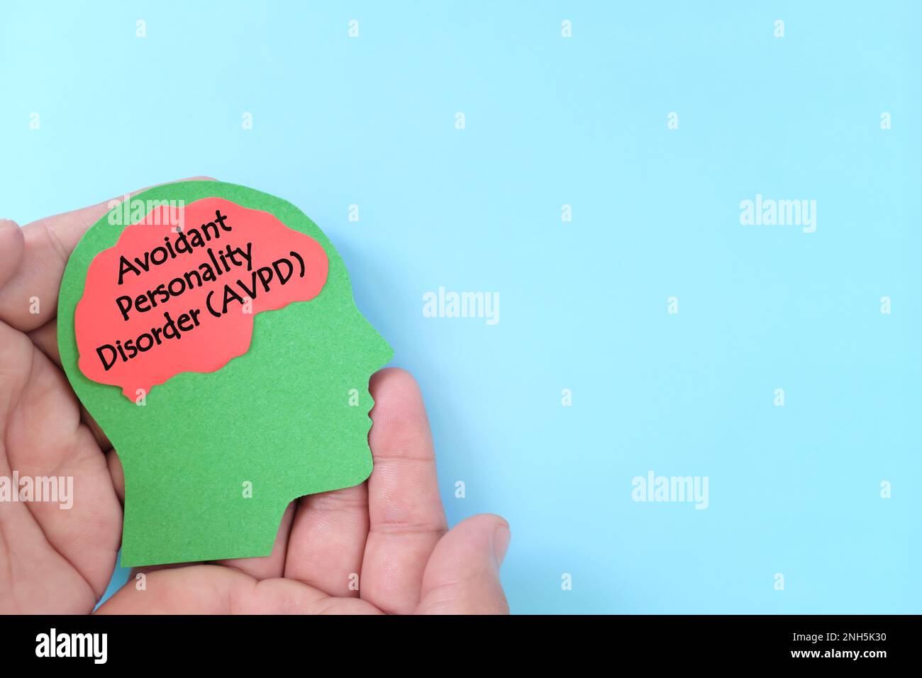 Avoidant personality disorder help, care and treatment concept. Hand holding human head profile ...