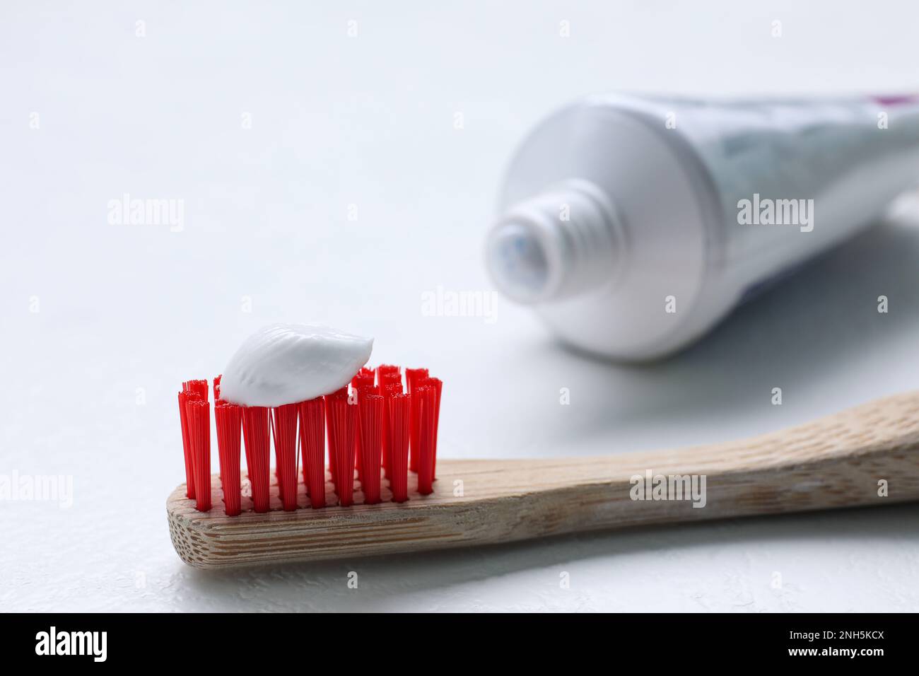 Brush with toothpaste and tube on white background, closeup Stock Photo ...