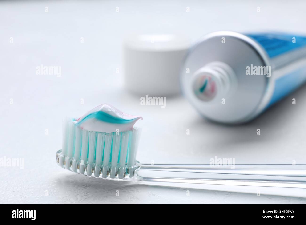Brush with toothpaste and tube on white background, closeup Stock Photo ...