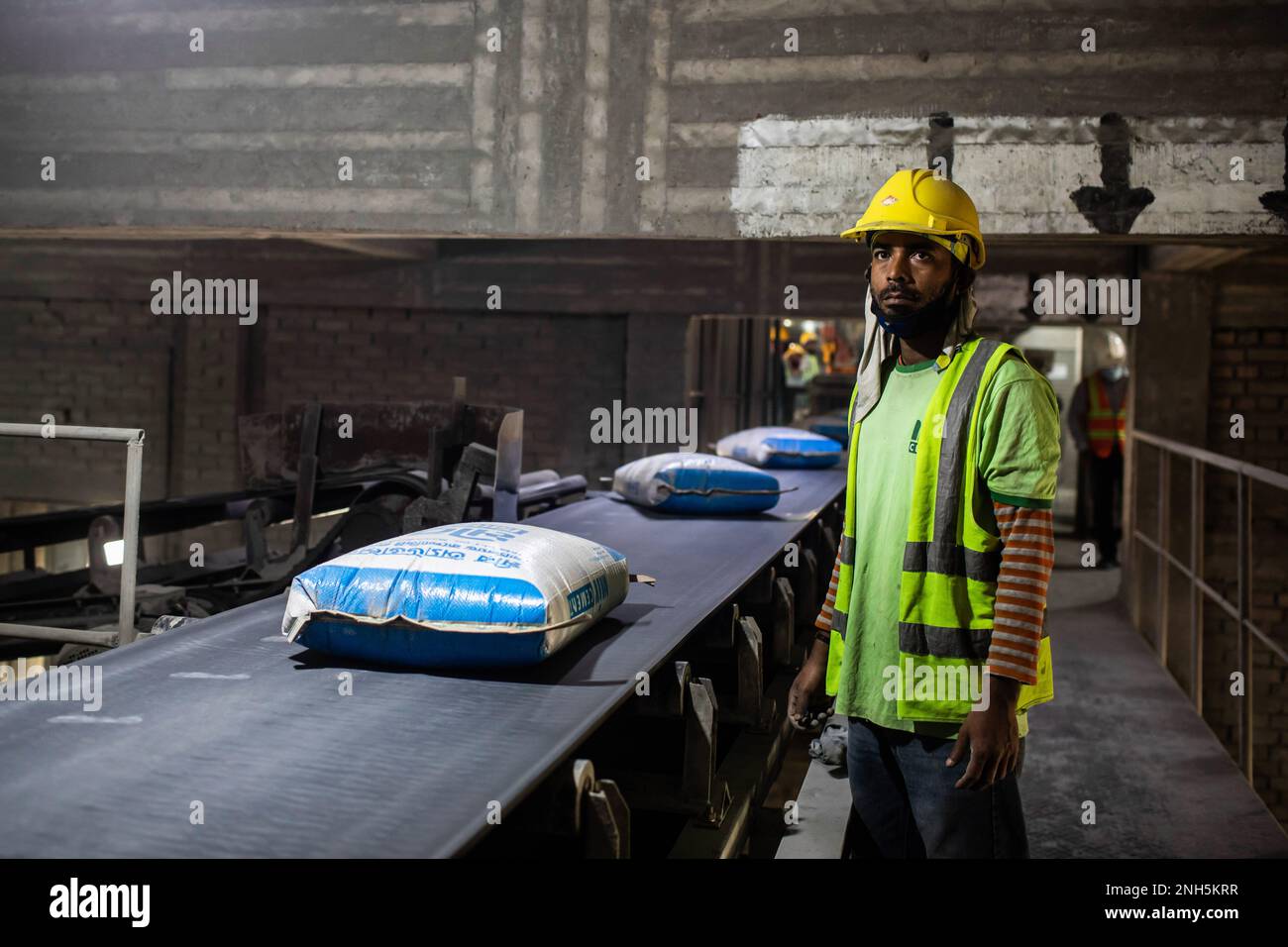 A laborer seen working at the Mir cement plant. Mir Cement Ltd is going ...