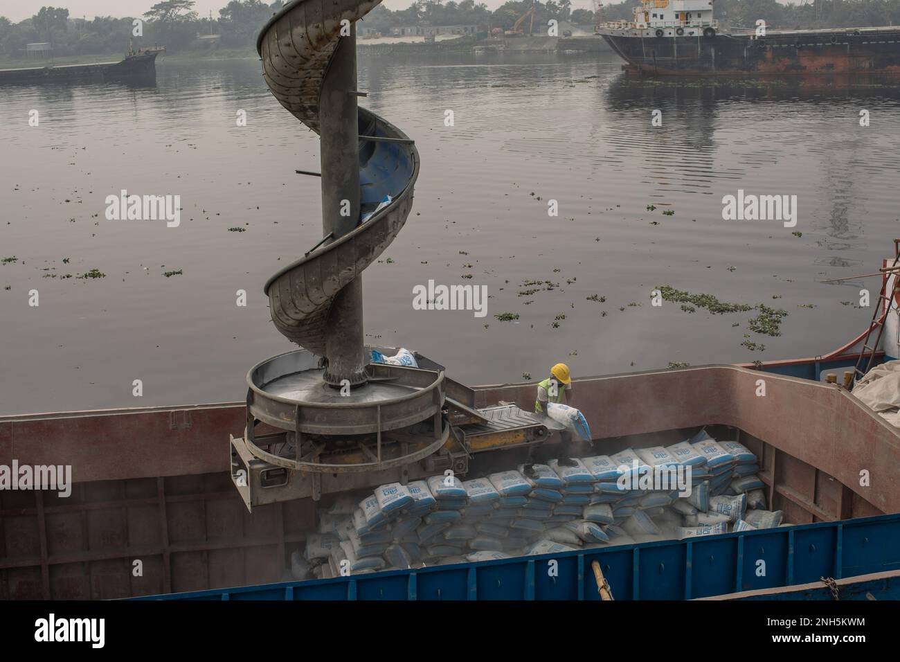 A worker collects cement bags at the Mir cement plant. Mir Cement Ltd ...