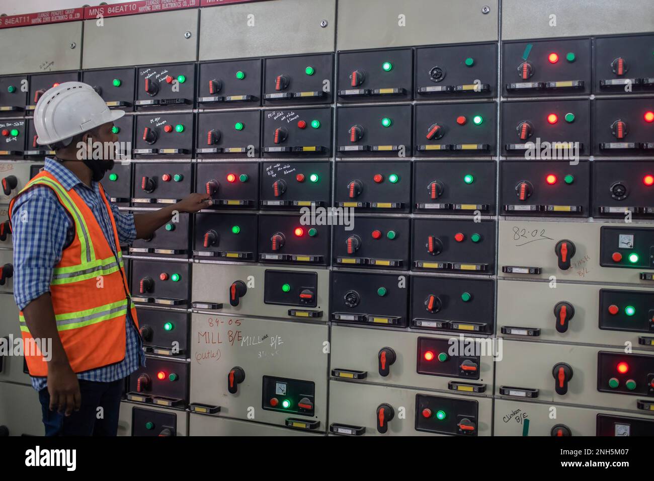 A worker operates a machine at the Mir cement plant. Mir Cement Ltd is ...