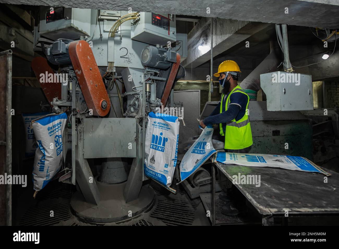 A worker seen loading cement material in the bags at the Mir cement ...