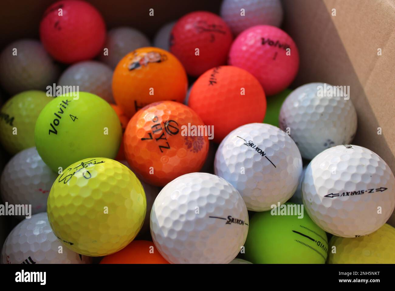 Colorful golf balls in cardboard box Stock Photo - Alamy