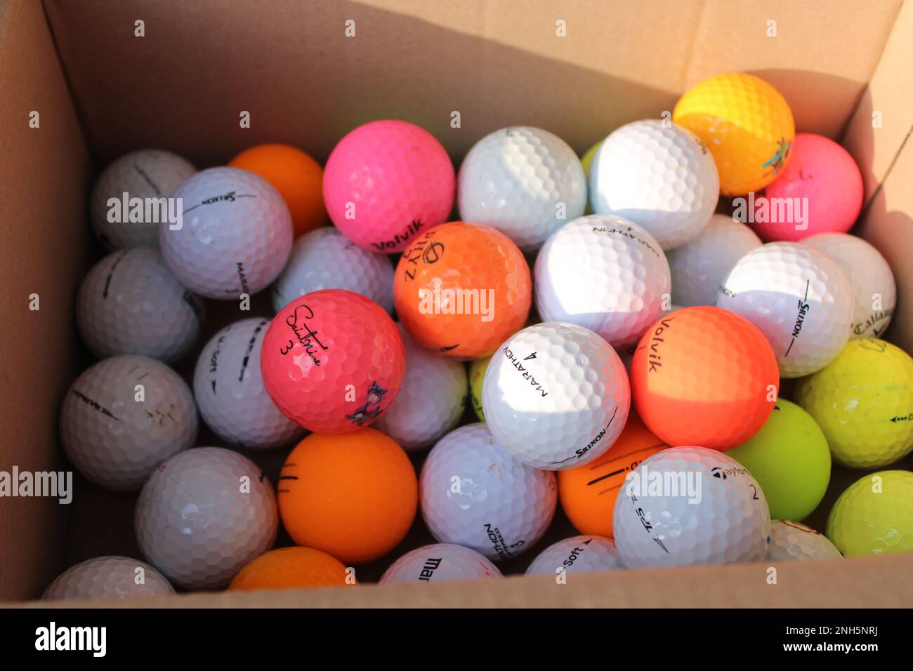 Colorful golf balls in cardboard box Stock Photo - Alamy