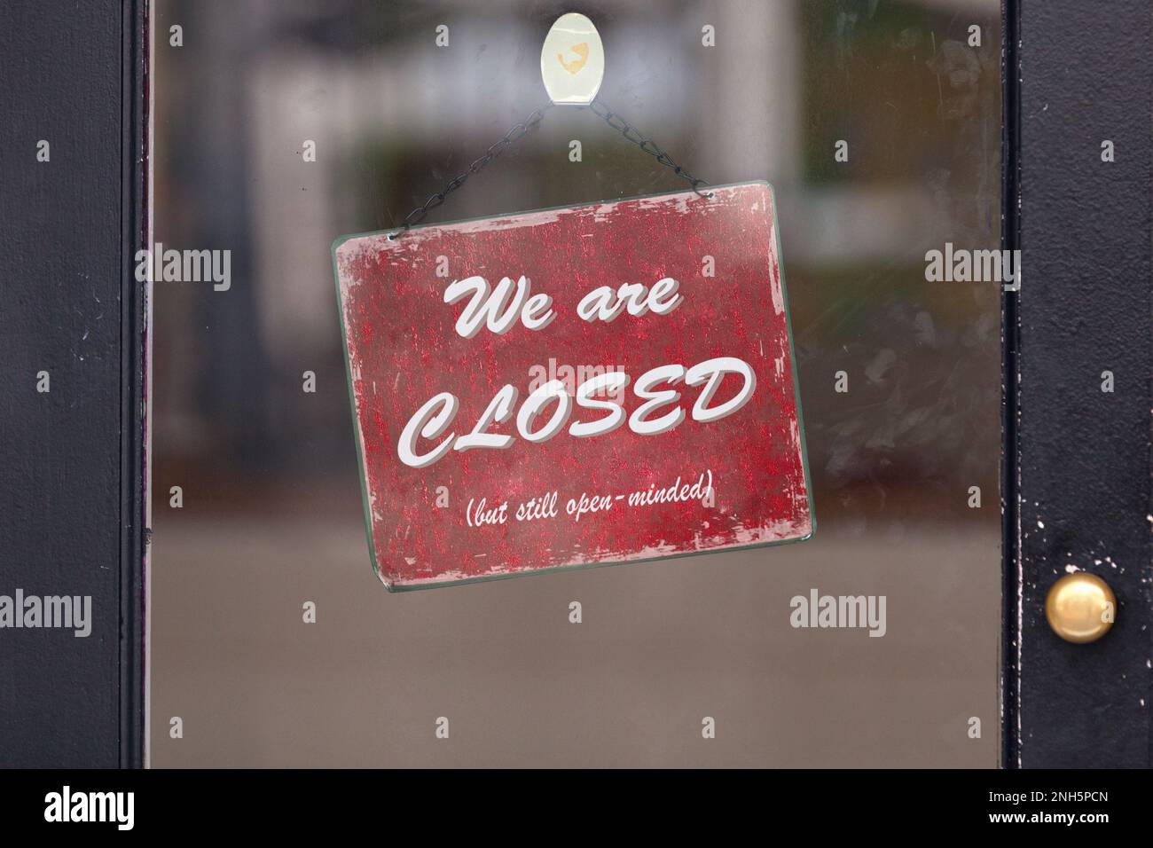 Closed sign with written in it "We are closed (but still open-minded ...