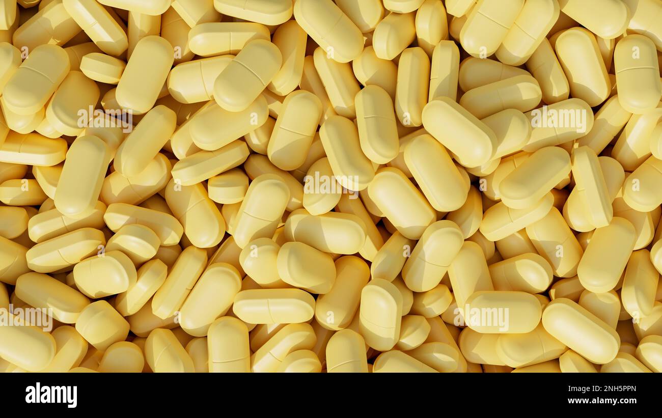 Pile of light yellow tablets or drug pills background. medicine ...