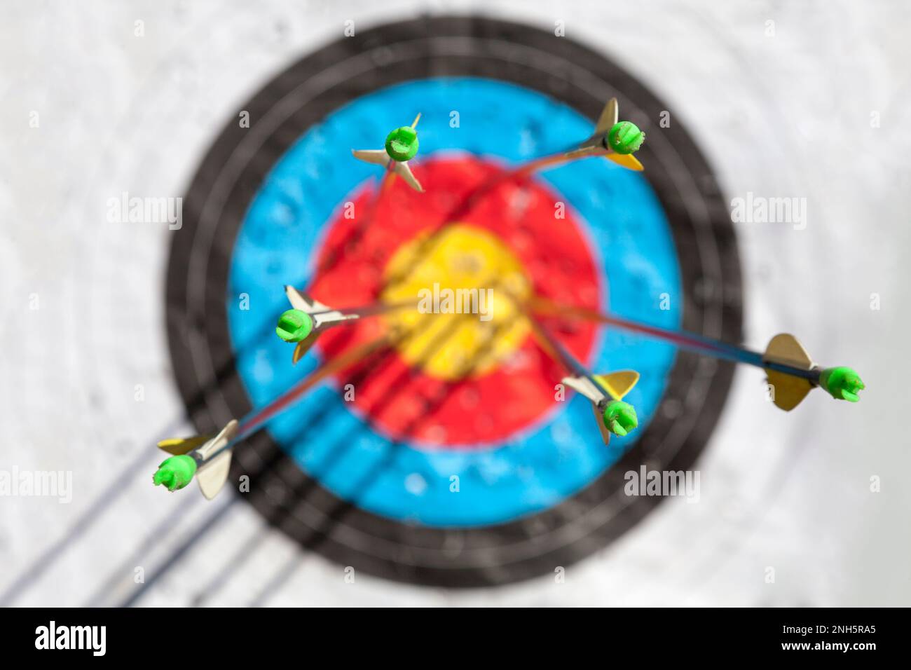 One out of six arrows in the bull's-eye of an archery target. Selective ...