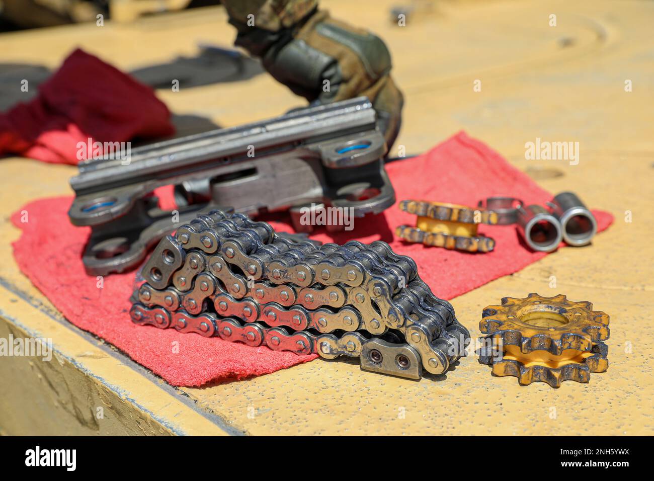 Parts belonging to an M242 Bushmaster chain gun sit on the door of an ...