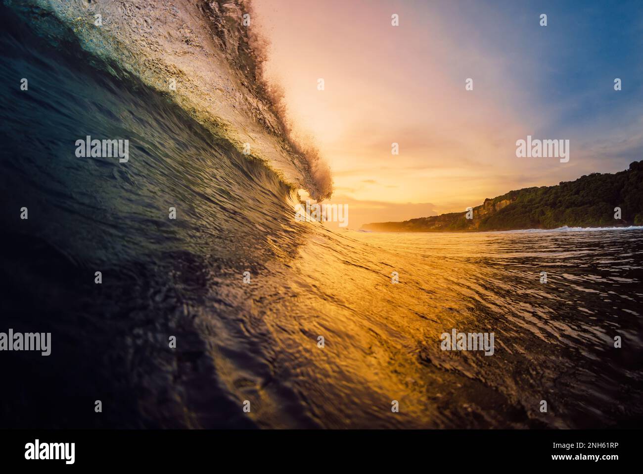 Perfect barrel wave crashing in ocean on warm sunset or sunrise Stock ...