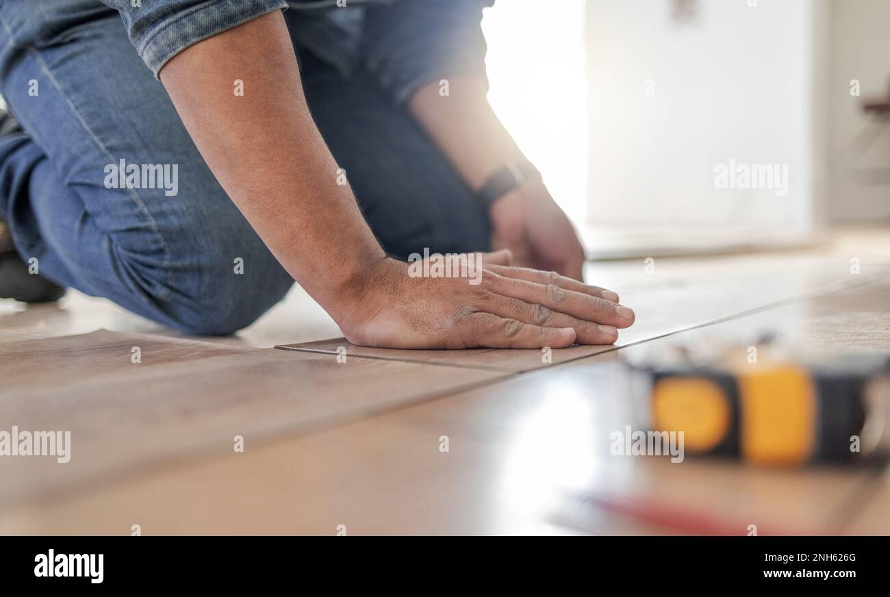 Construction worker hands, wood carpenter and home floor renovation of ...