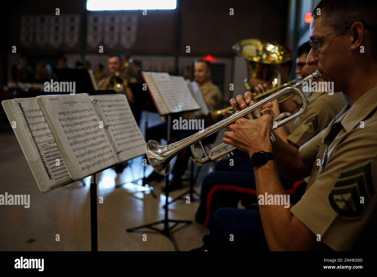 U.S. Marine Corps Staff Sgt. Kyle Schlick, a trumpet player, plays the ...