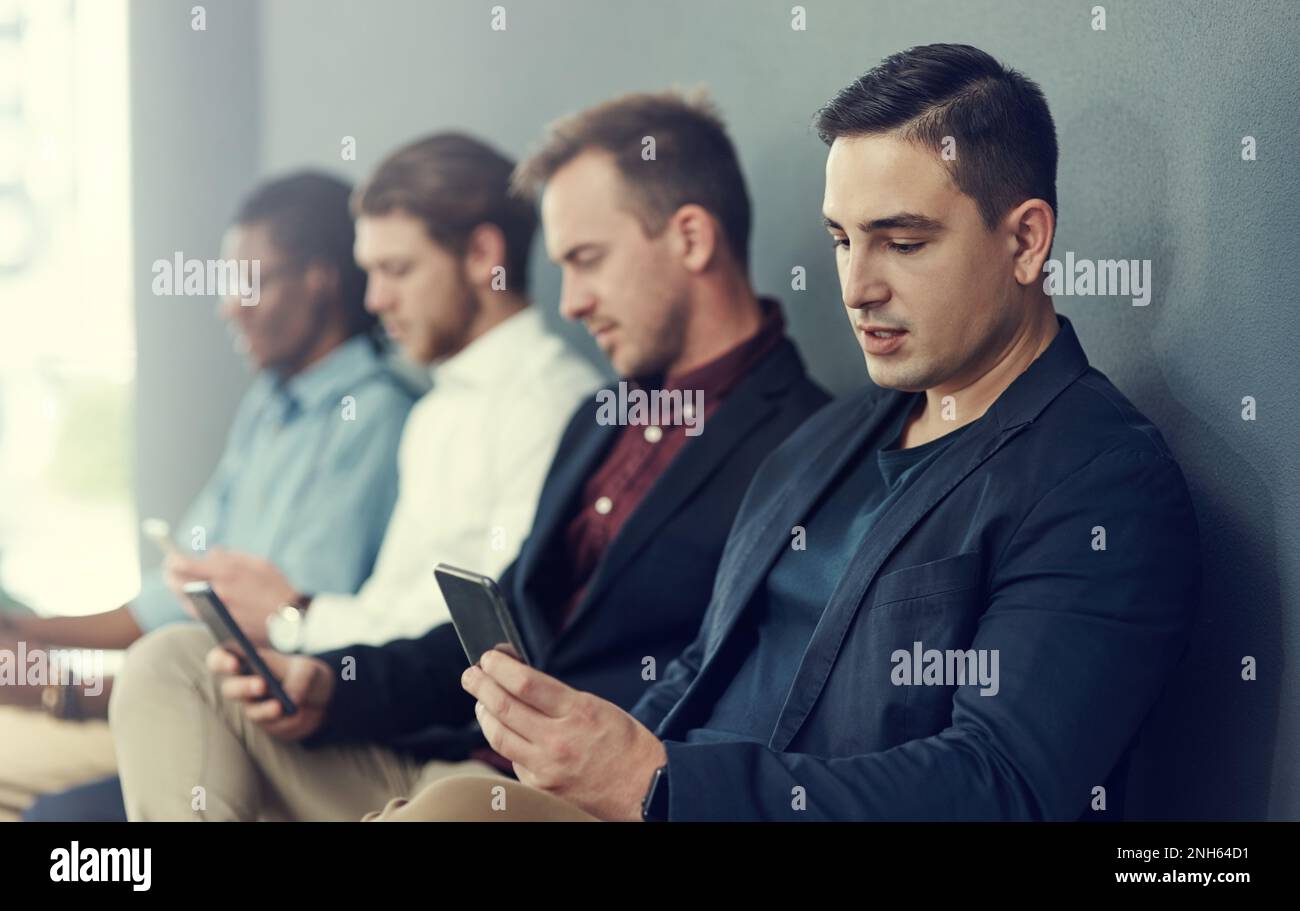 The candidates are staying connected. a group of businessmen using ...