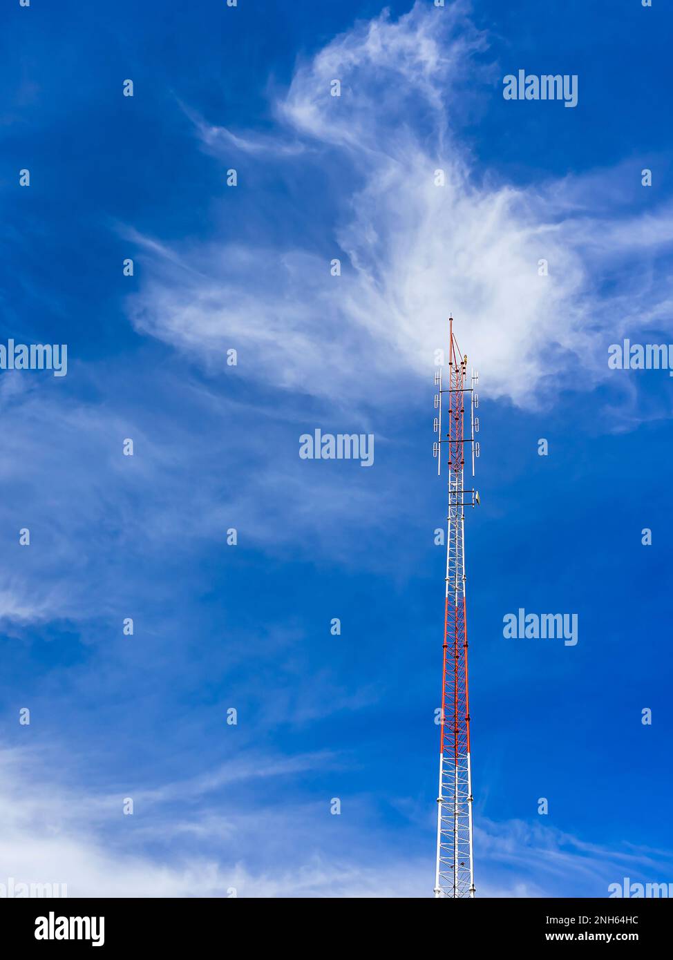 Telecommunication radio wave signal tower red and white with cloudy. Steel truss of transmission ...