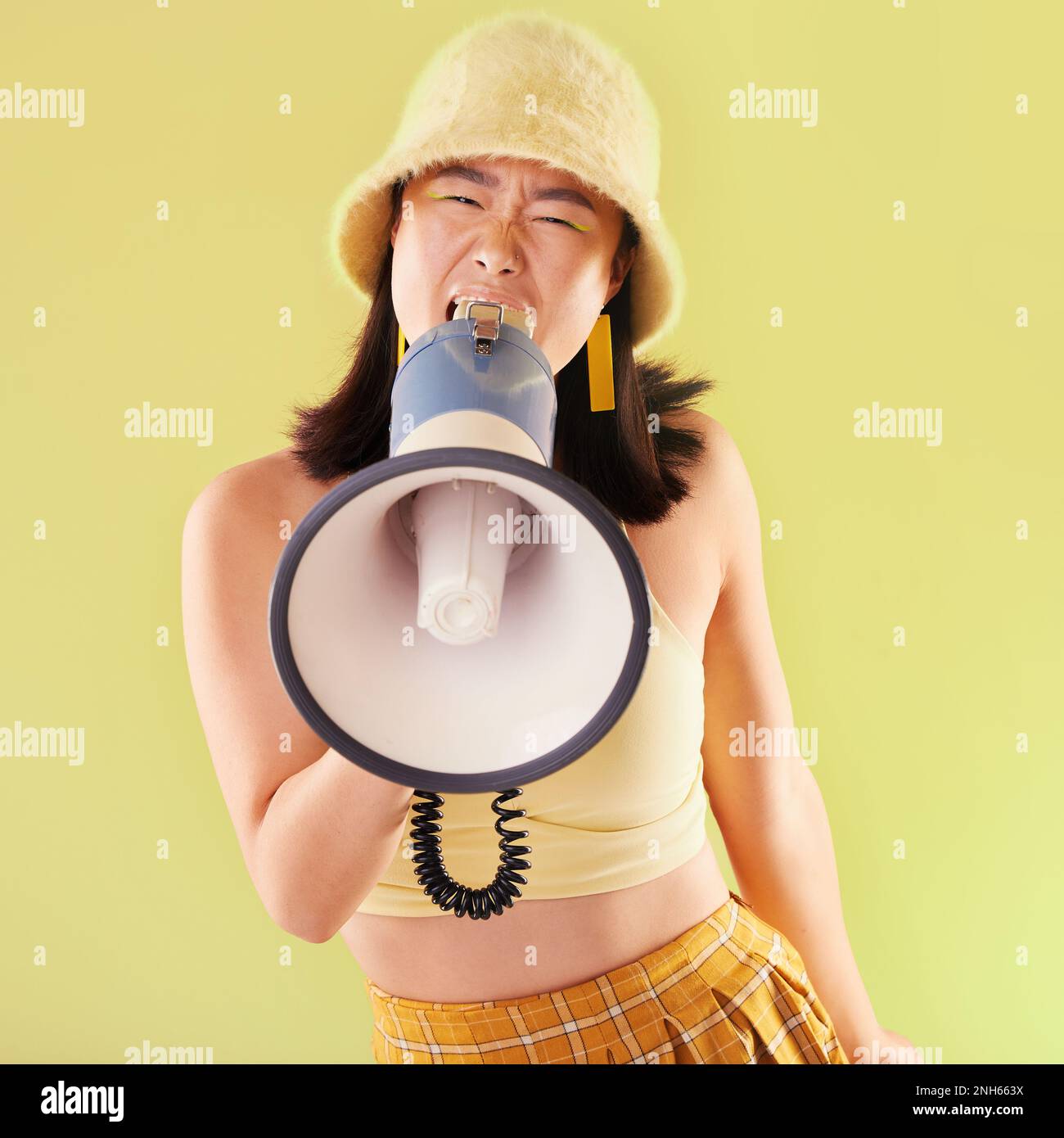 Asian, woman and studio with megaphone for protest, speech and activism ...