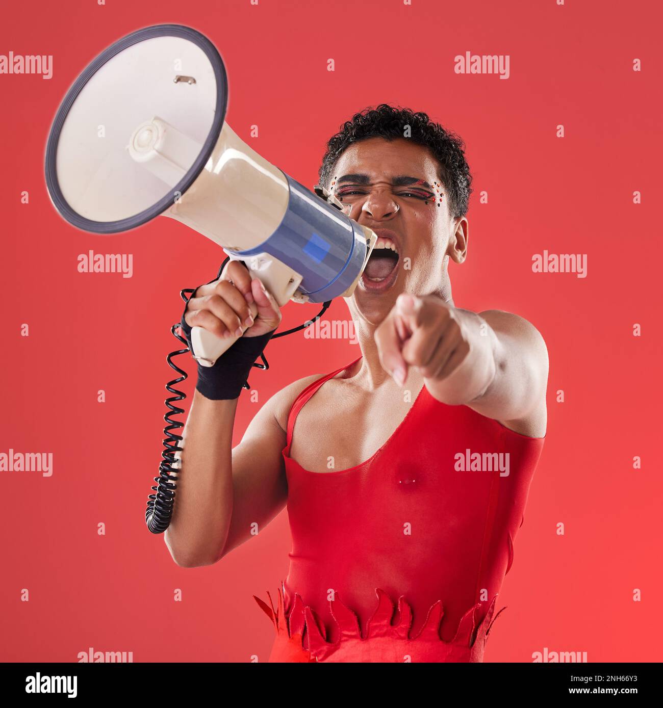Anger, gay and portrait of a man with a megaphone isolated on a red ...